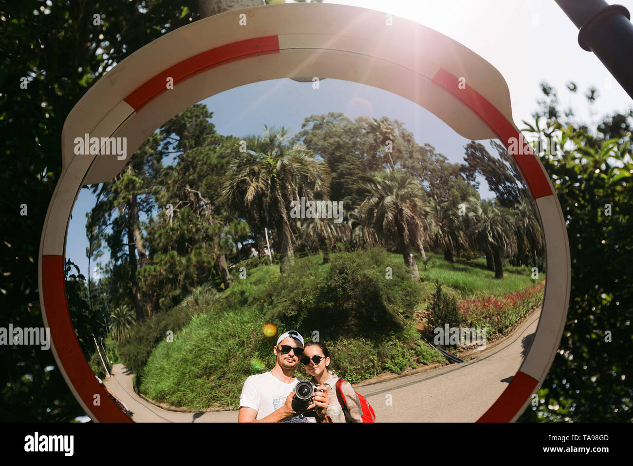 couple of tourists doing a sephi in a mirror in the park Stock Photo ...