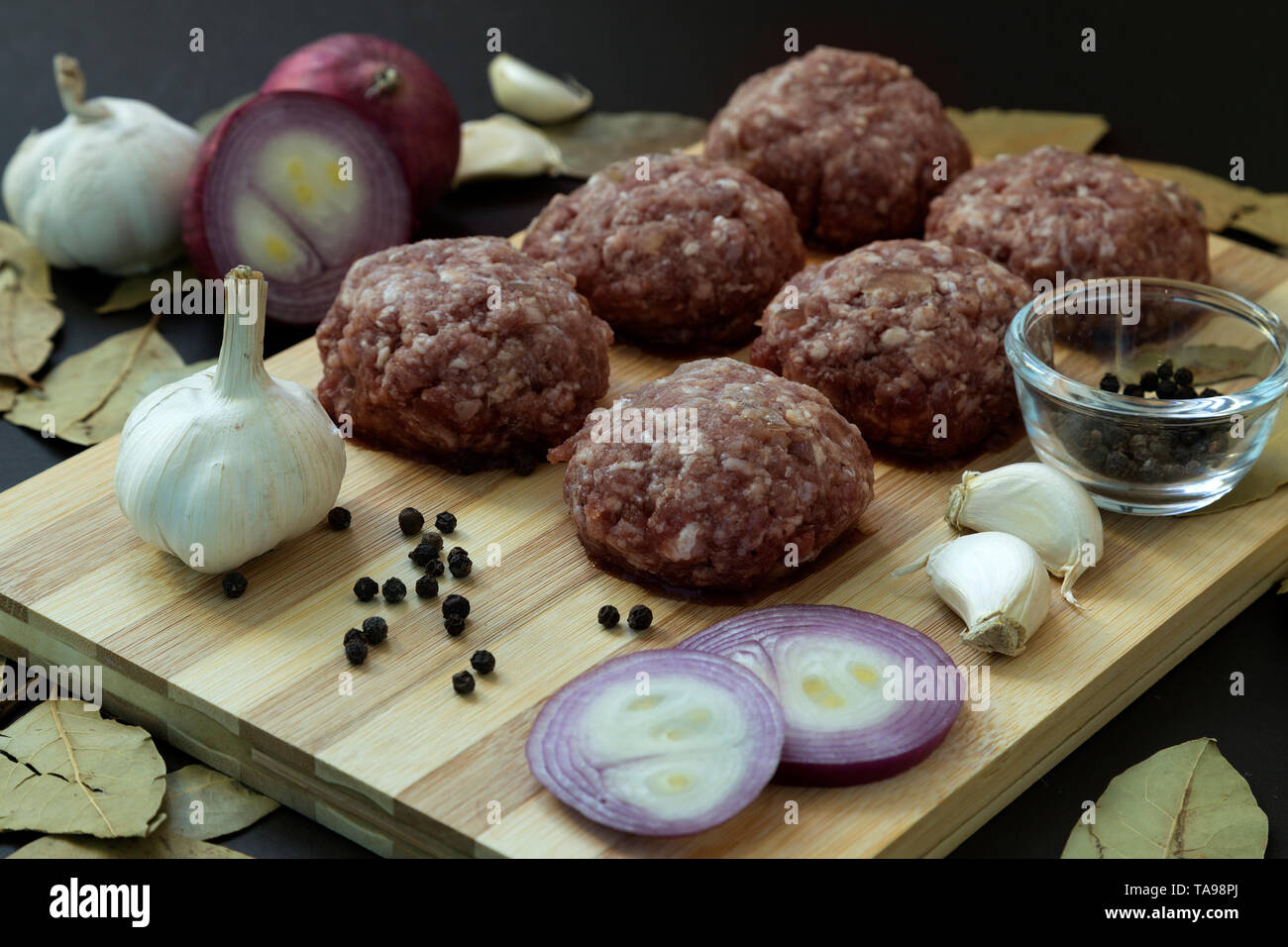 Raw uncooked meatballs on a board Stock Photo - Alamy