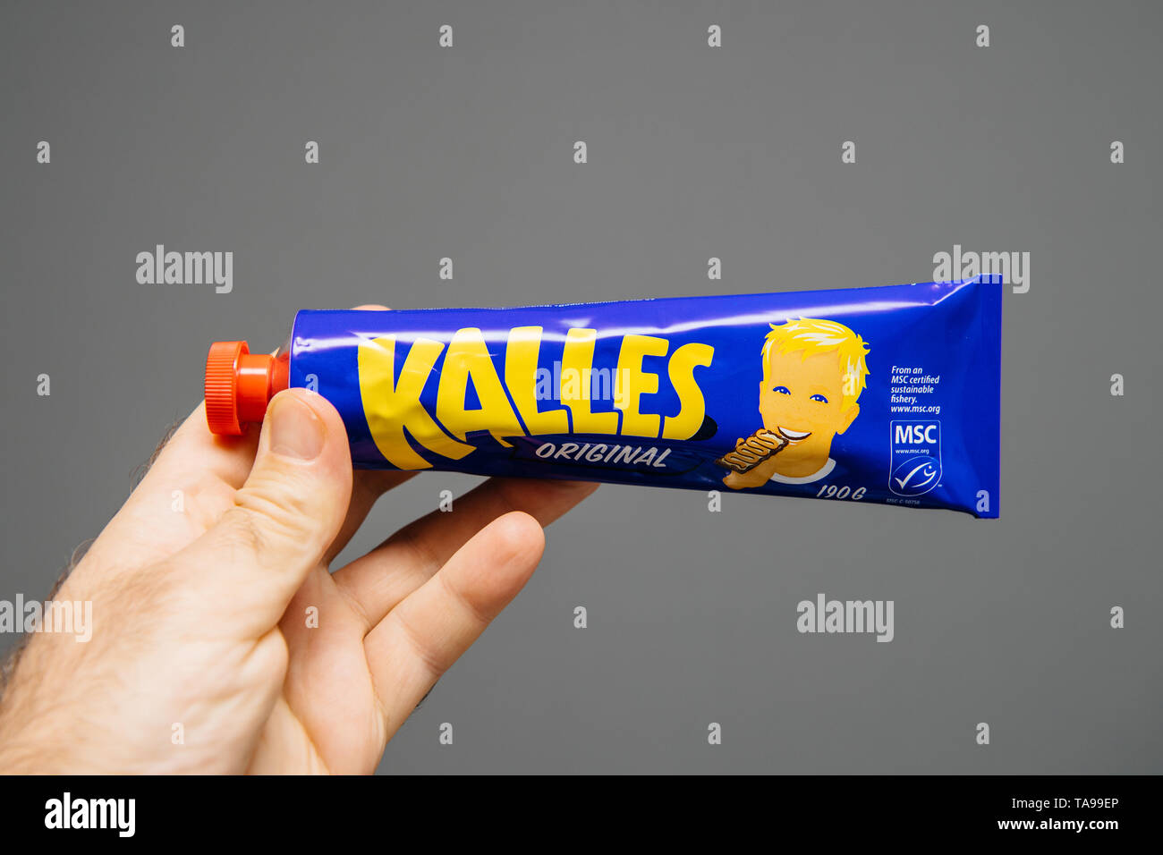 Delft, Netherlands - Apr 6, 2019: Male hand holding tube with Kalles ...