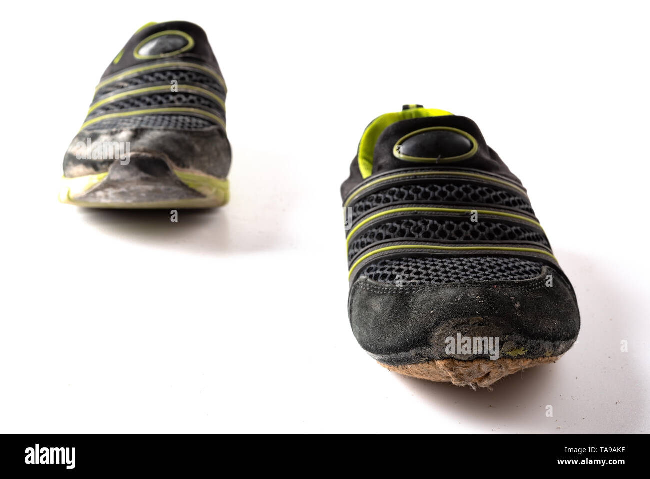 pair of broken sporty shoes on white background Stock Photo - Alamy