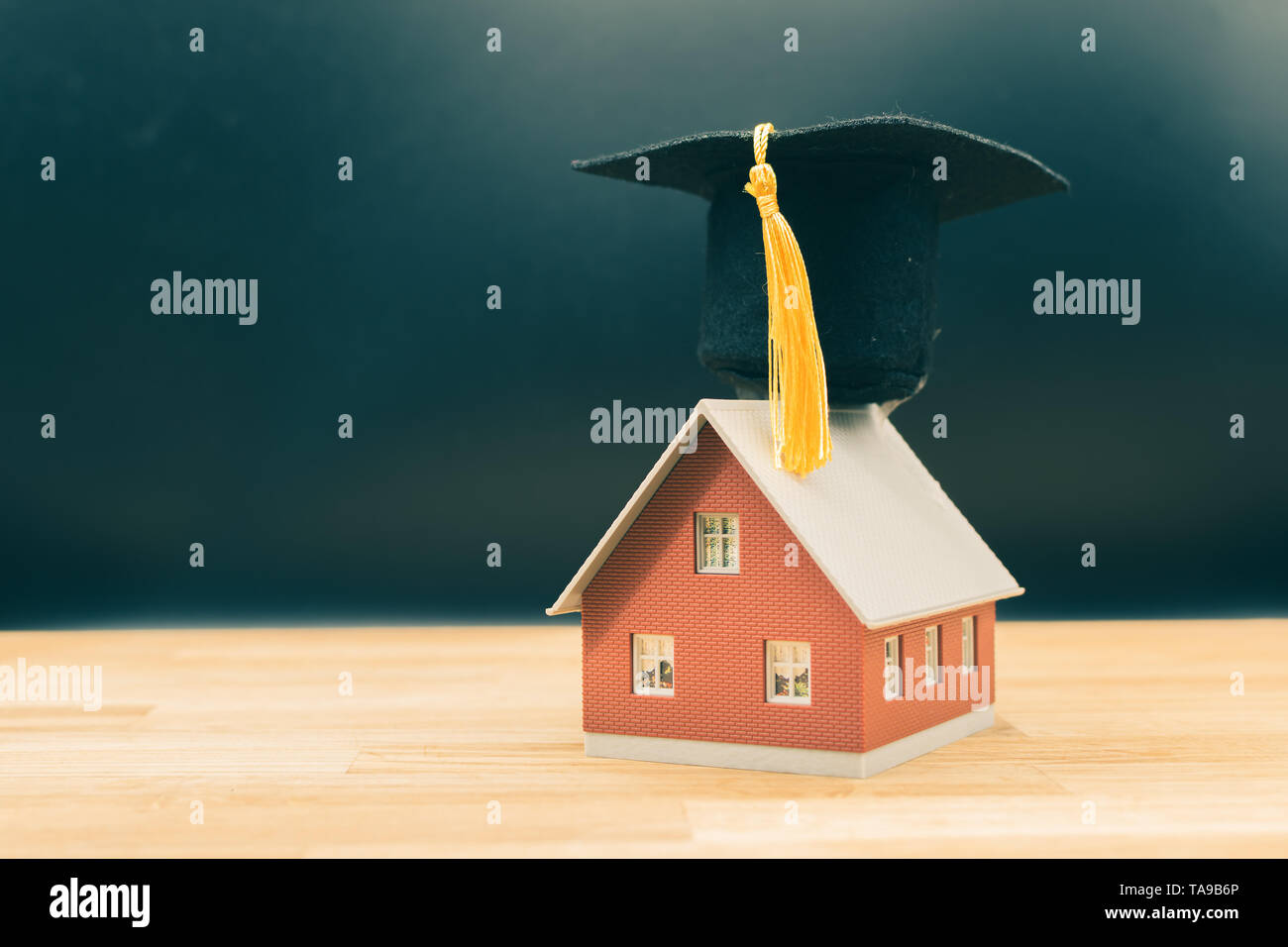 Concept for a smart home. A model house wears a graduation hat Stock ...