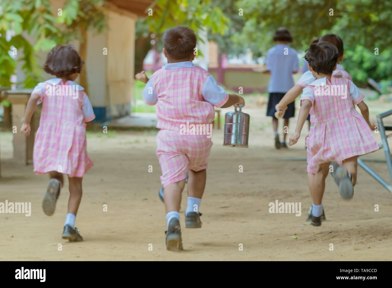 Back view of Kindergarten students run back to the classroom after ...