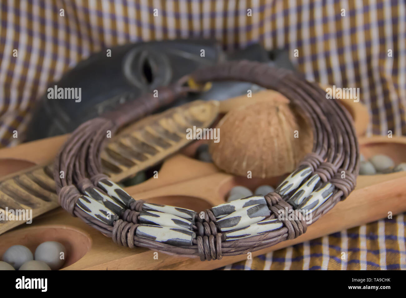 African tribal necklace with background made of African artifacts ...