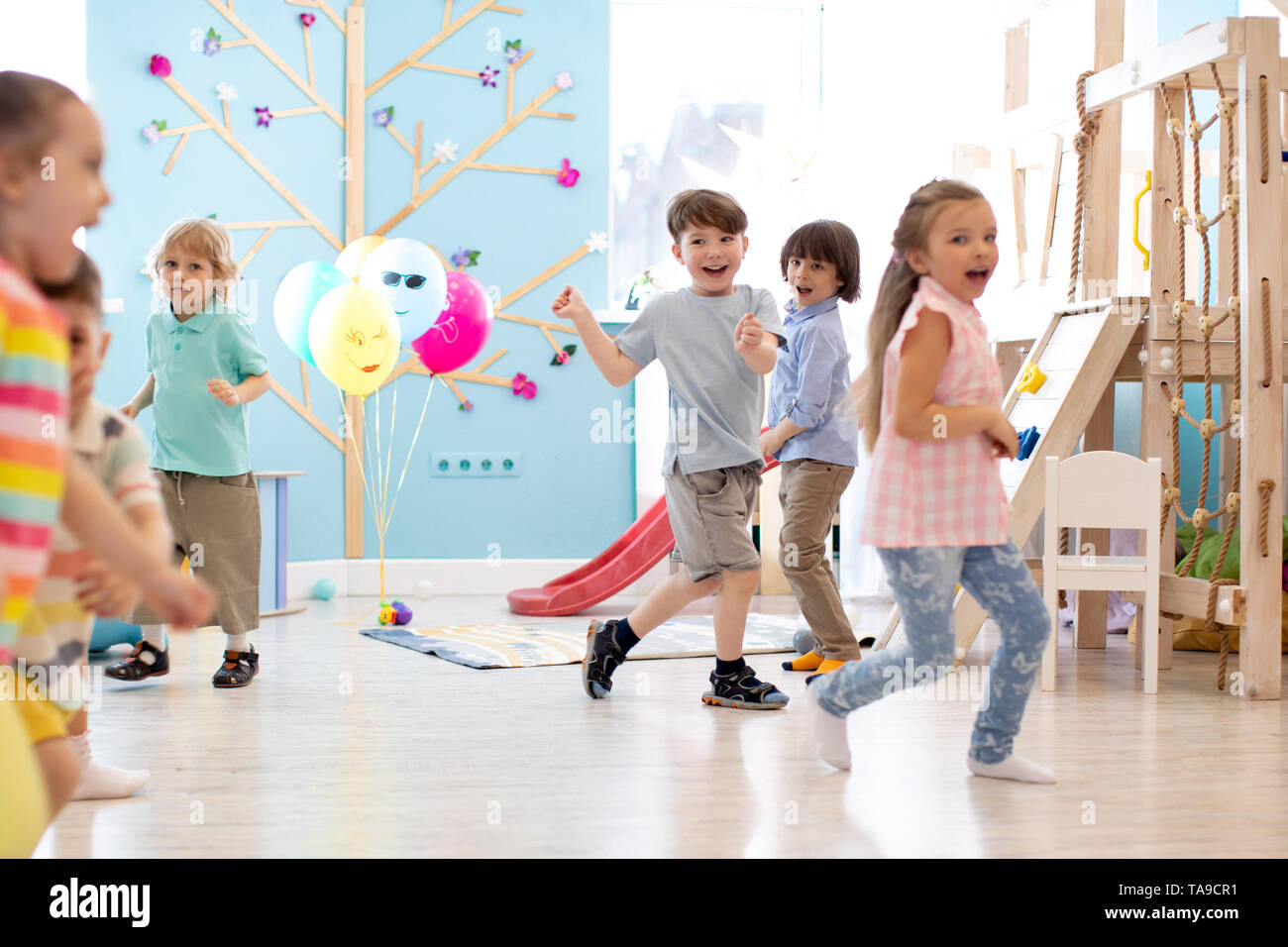 childhood, leisure and people concept - group of happy children playing ...