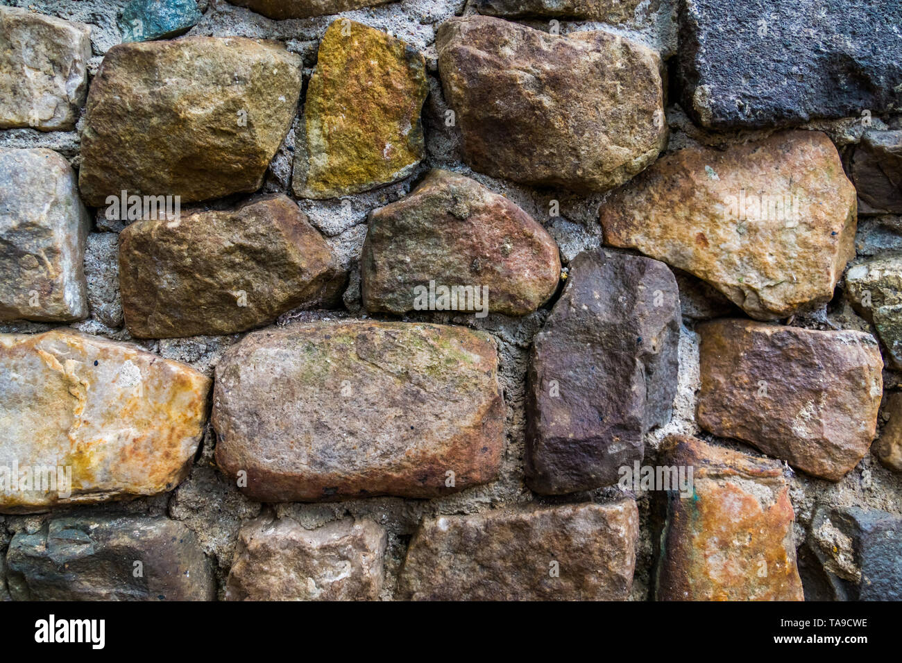 stone pattern in different sizes and colors, wall made of quarry rocks ...