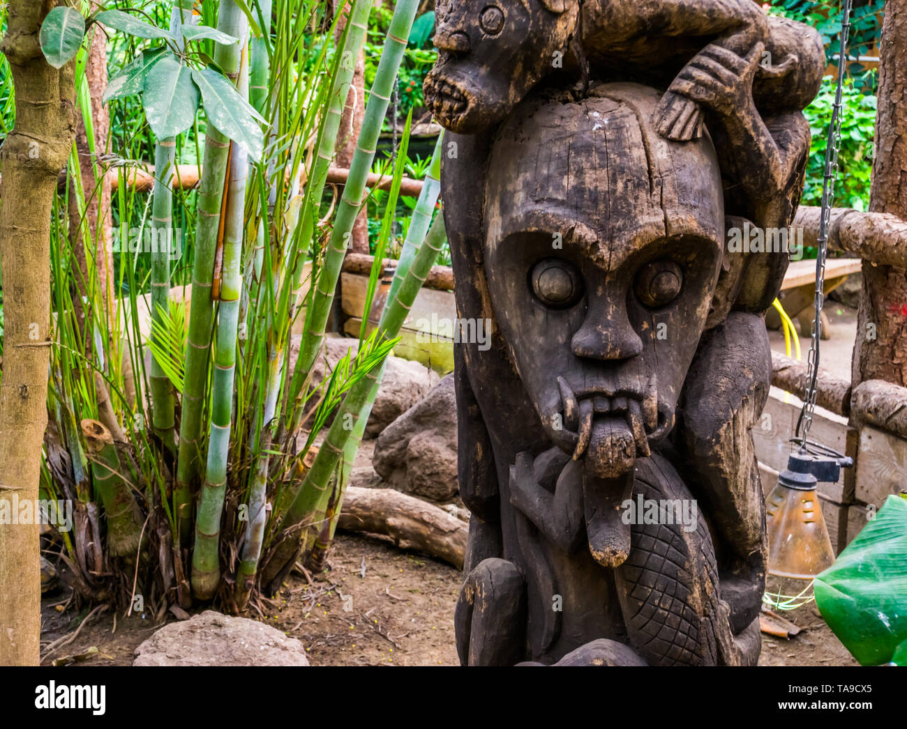 evil looking african carved wooden sculpture, traditional garden ...