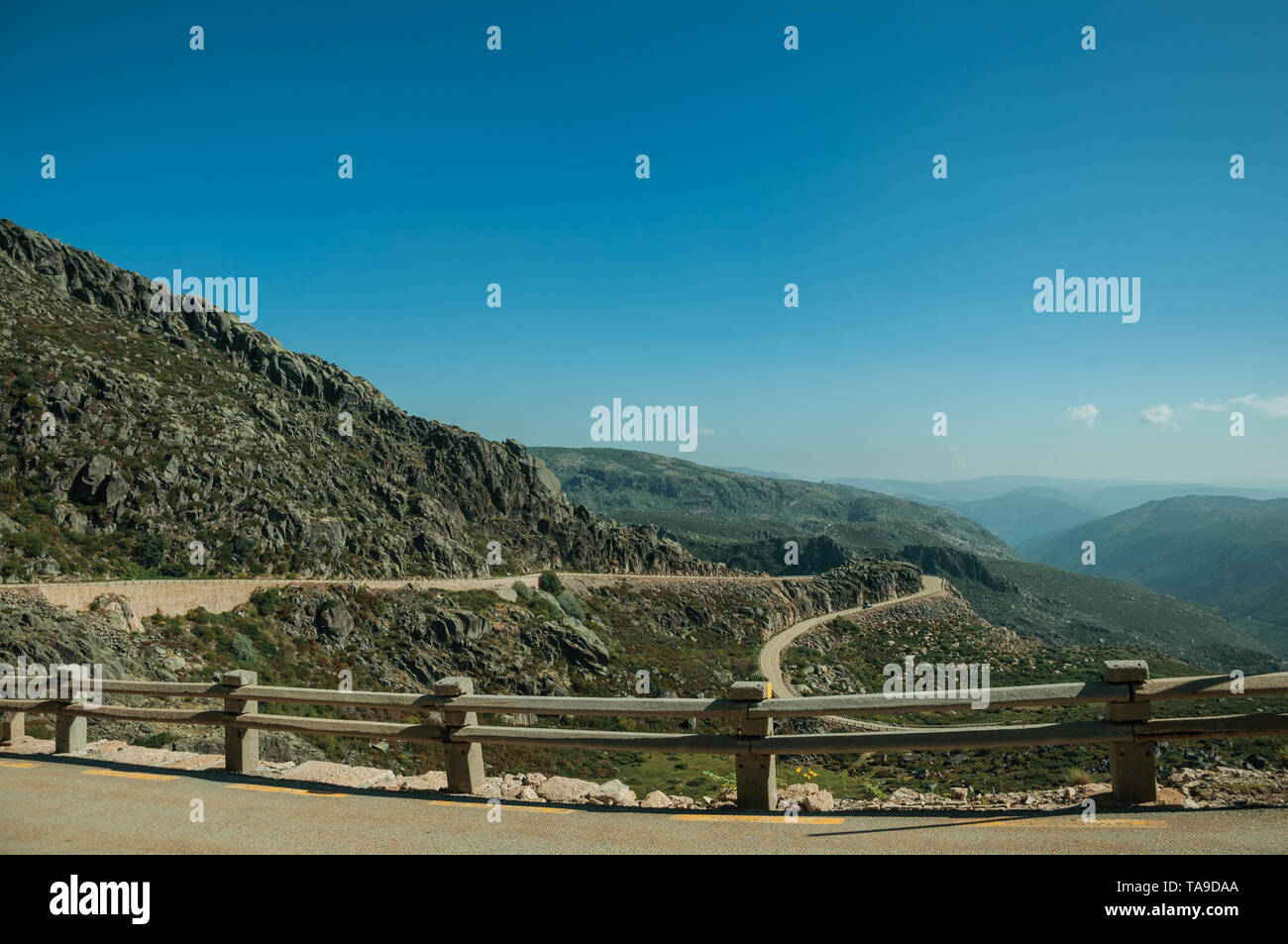 Concrete parapet on edge of road on rocky landscape at the highlands of ...