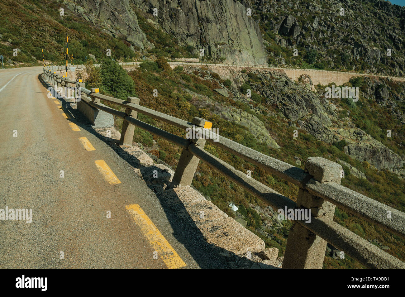 Broken concrete parapet in road on rocky landscape at the highlands of ...