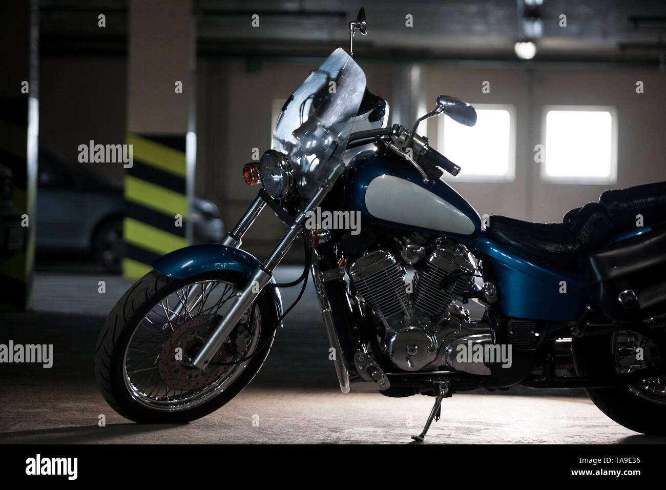 A chopper motorcycle silhouette. Motorbike standing in dark underground ...