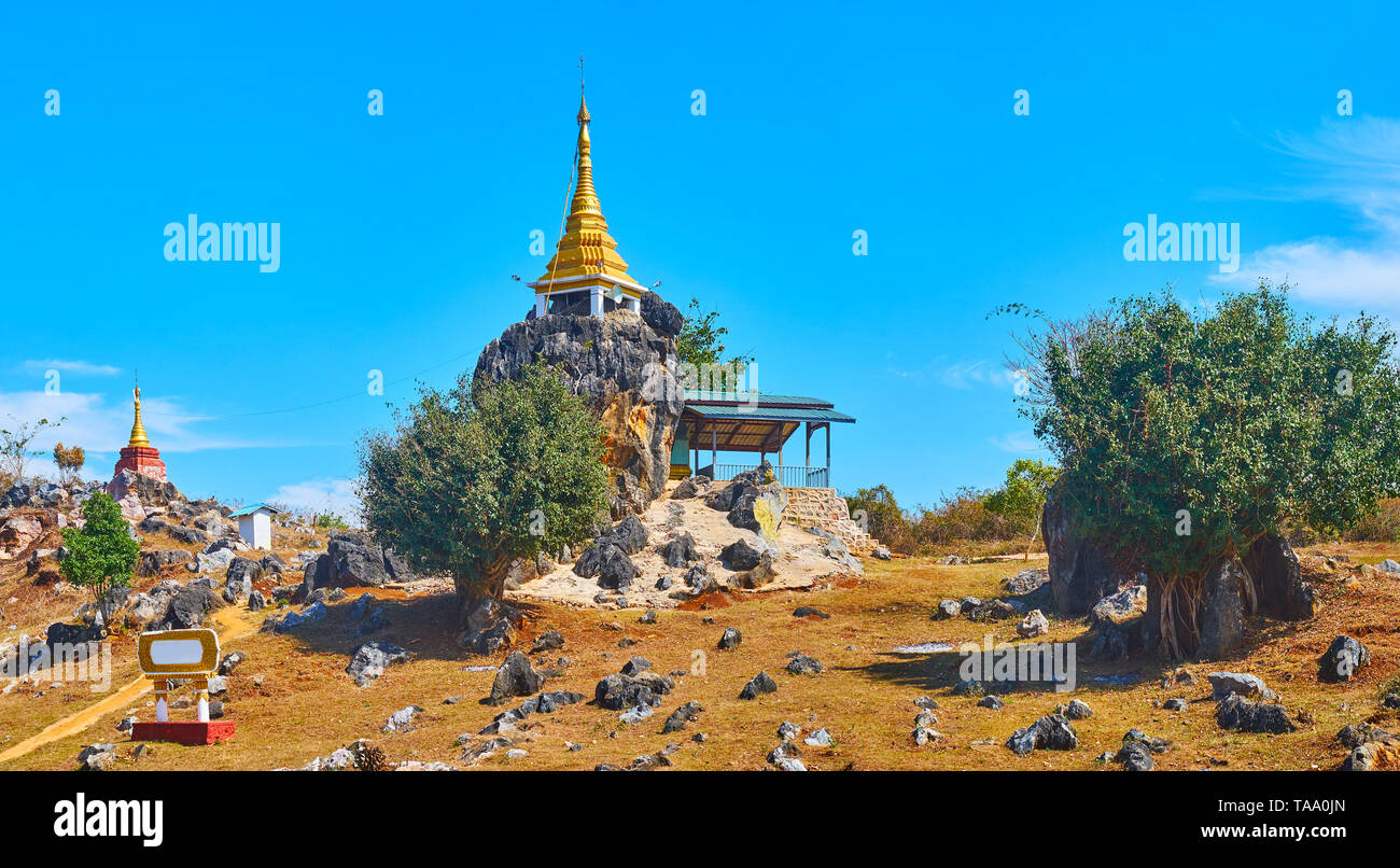 The scenic small rock temple in Pindaya suburb with ornate golden ...