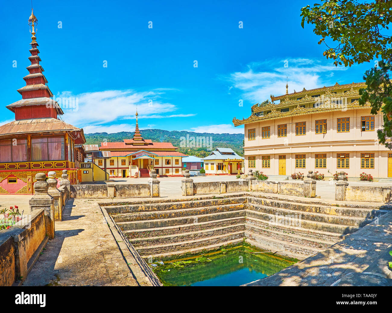 The old and modern buildings of Kan Tu Kyaung monastery with a small ...