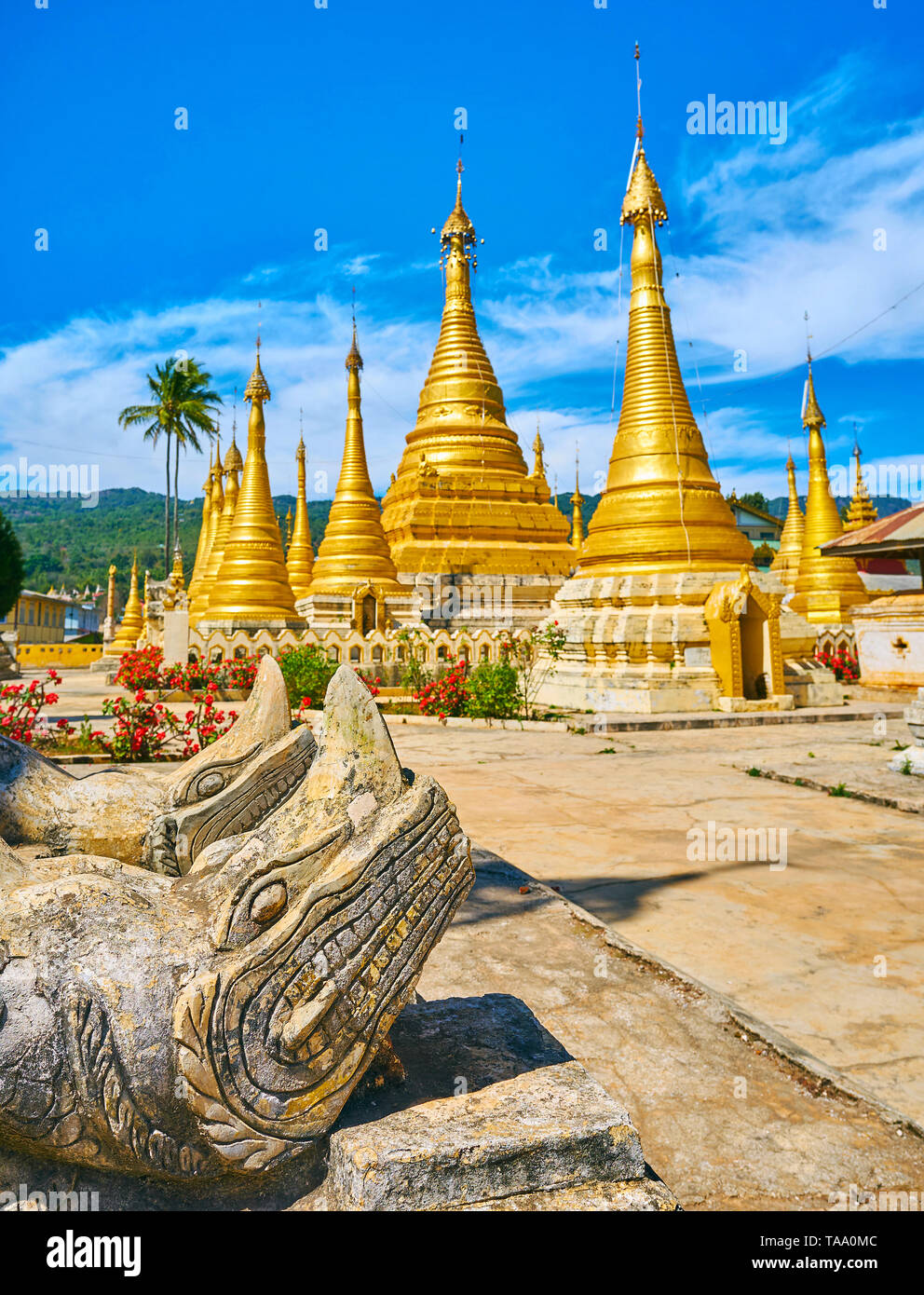 The view on tall golden pagodas of Kan Tu Kyaung monastery and the ...