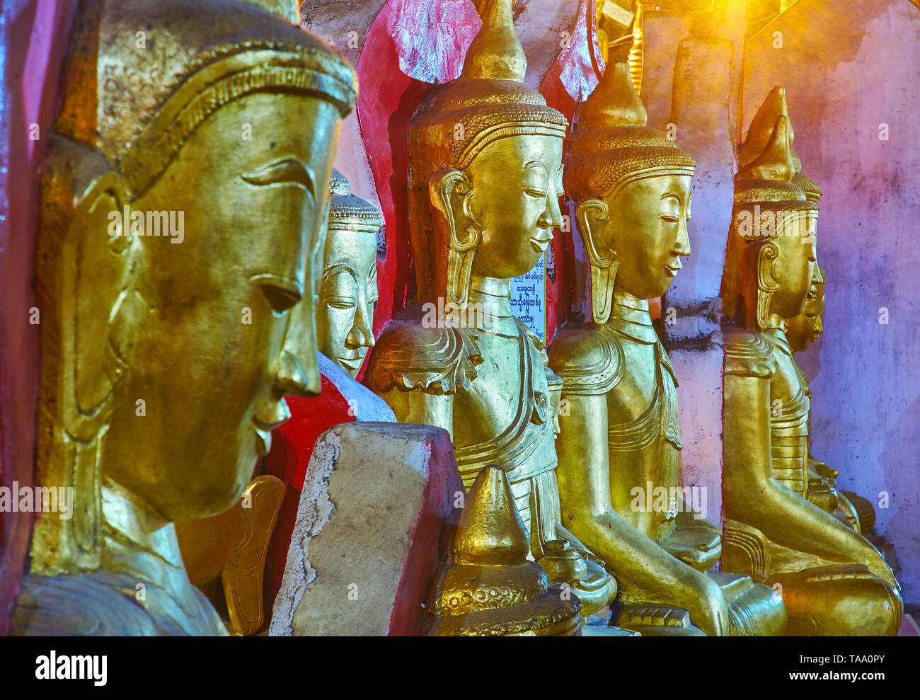 PINDAYA, MYANMAR - FEBRUARY 19, 2018: Observe historic gilded Buddha ...