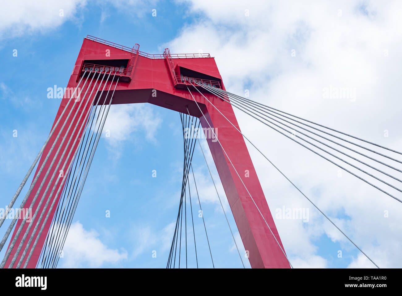 Willemsbrug bridge red cable bridge against blue sky and white clouds ...