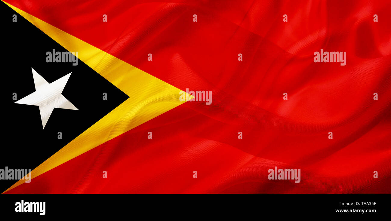 East Timor country flag symbol on silk or silky waving texture. Smooth ...