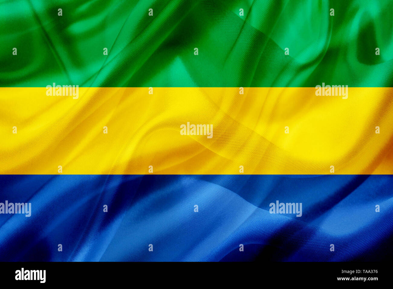 Gabon country flag symbol on silk or silky waving texture. Smooth ...