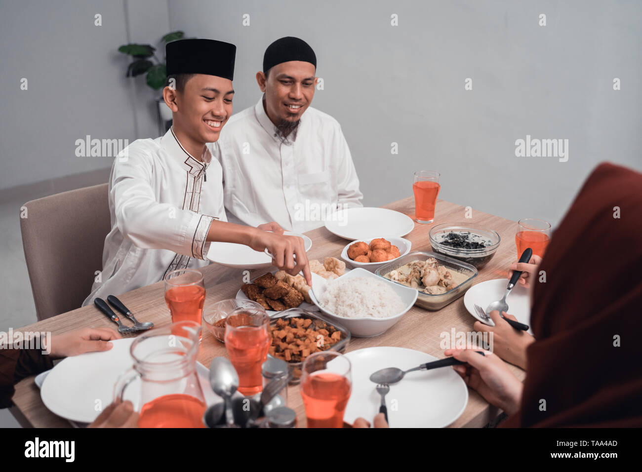 Muslim family celebrating eid dinner hi-res stock photography and ...
