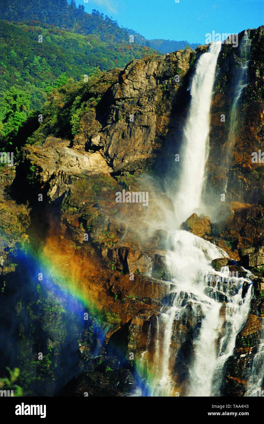 Waterfall with rainbow in himalayas India Stock Photo - Alamy