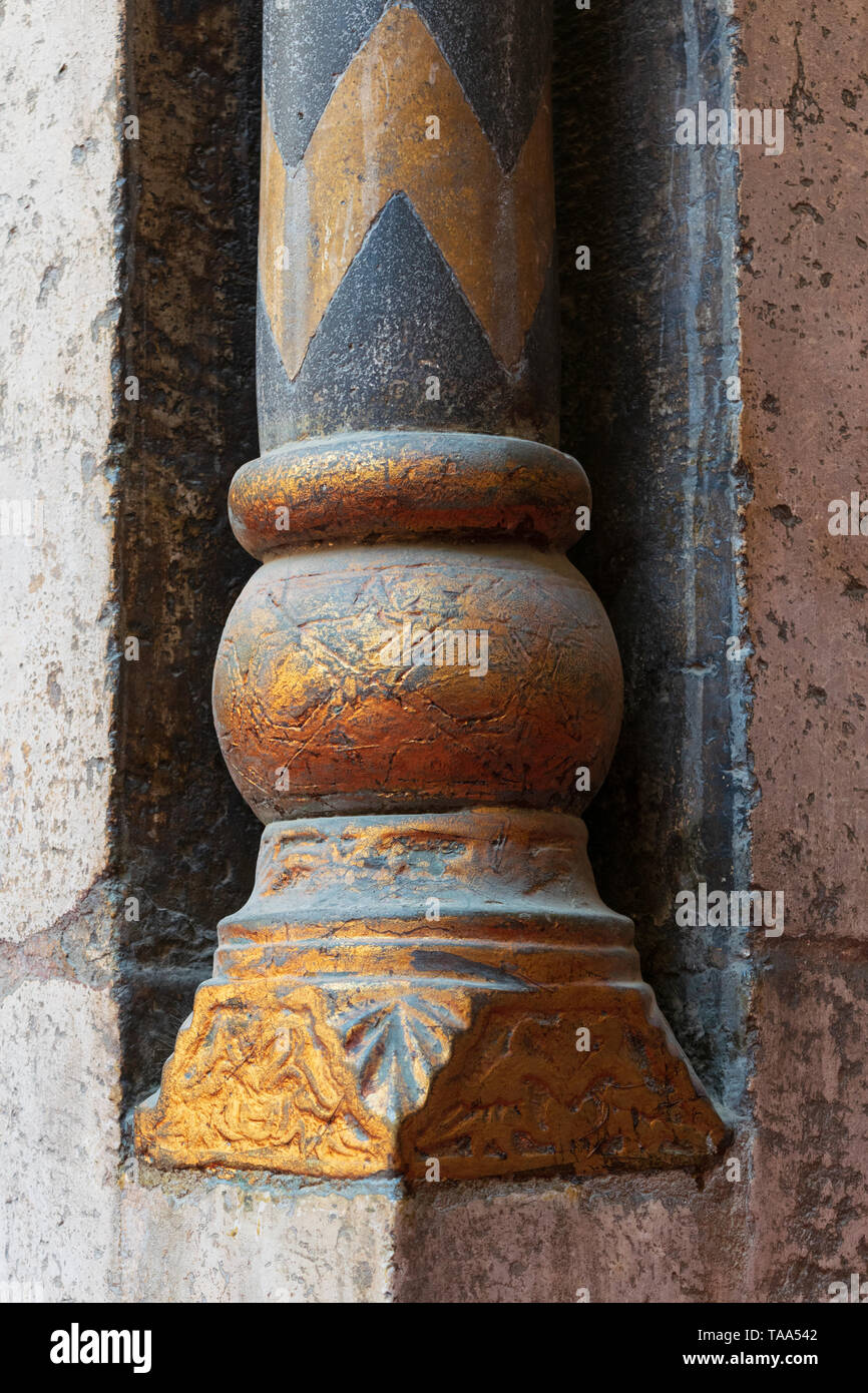 Golden base of a small decorative pillar (column) with engraved floral ...