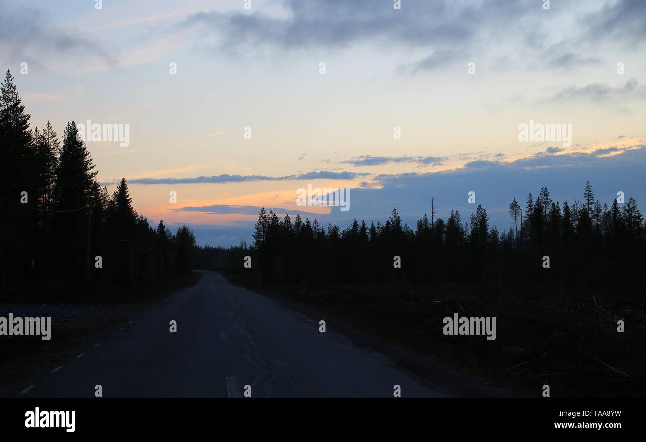 Light colored sunset and dark landscape in Northern Sweden Stock Photo ...