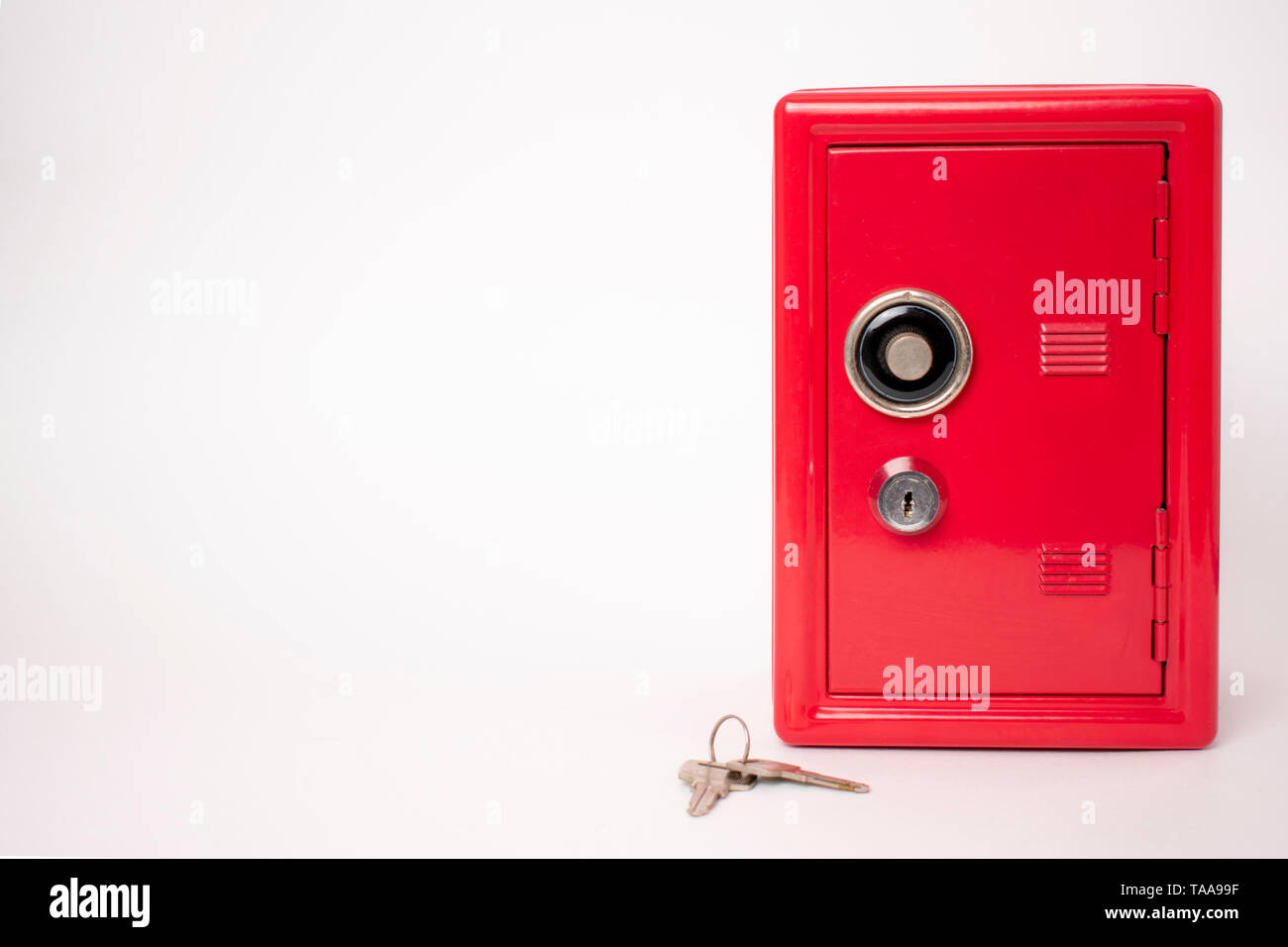 red safe on white background. bank with key Stock Photo - Alamy