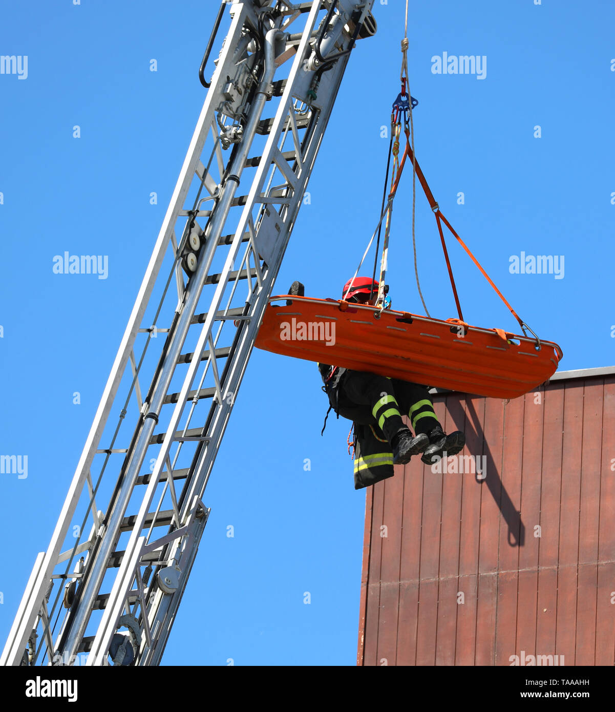 big crane and brave firefighter during a fire drill Stock Photo - Alamy