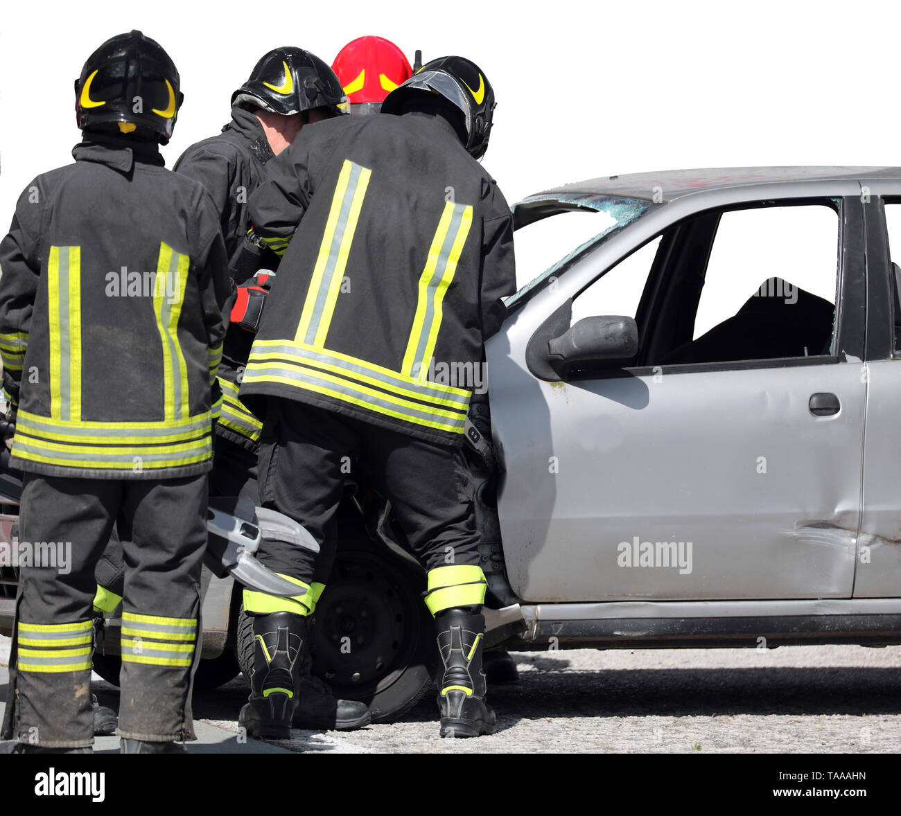 team of firefighters and a broken car after the road accident Stock ...