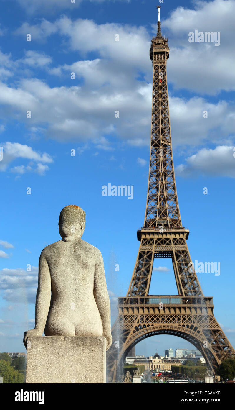 Statue of woman looks the big Eiffel Tower in Paris France Stock Photo ...