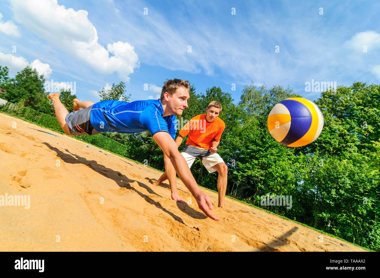 Intensive game on beachvolleyball court, fighting spirit to save the ...