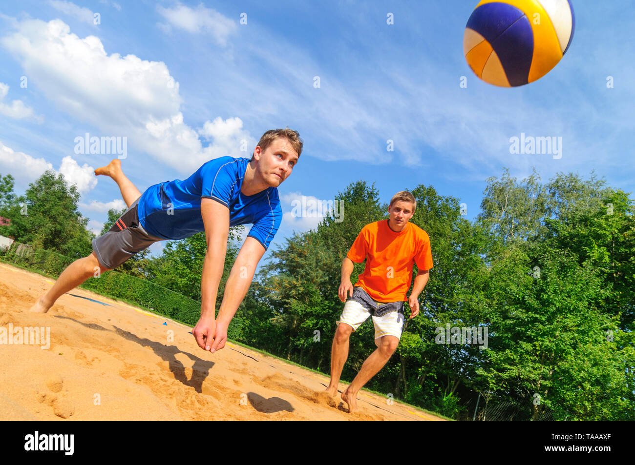 Intensive game on beachvolleyball court, fighting spirit to save the ...