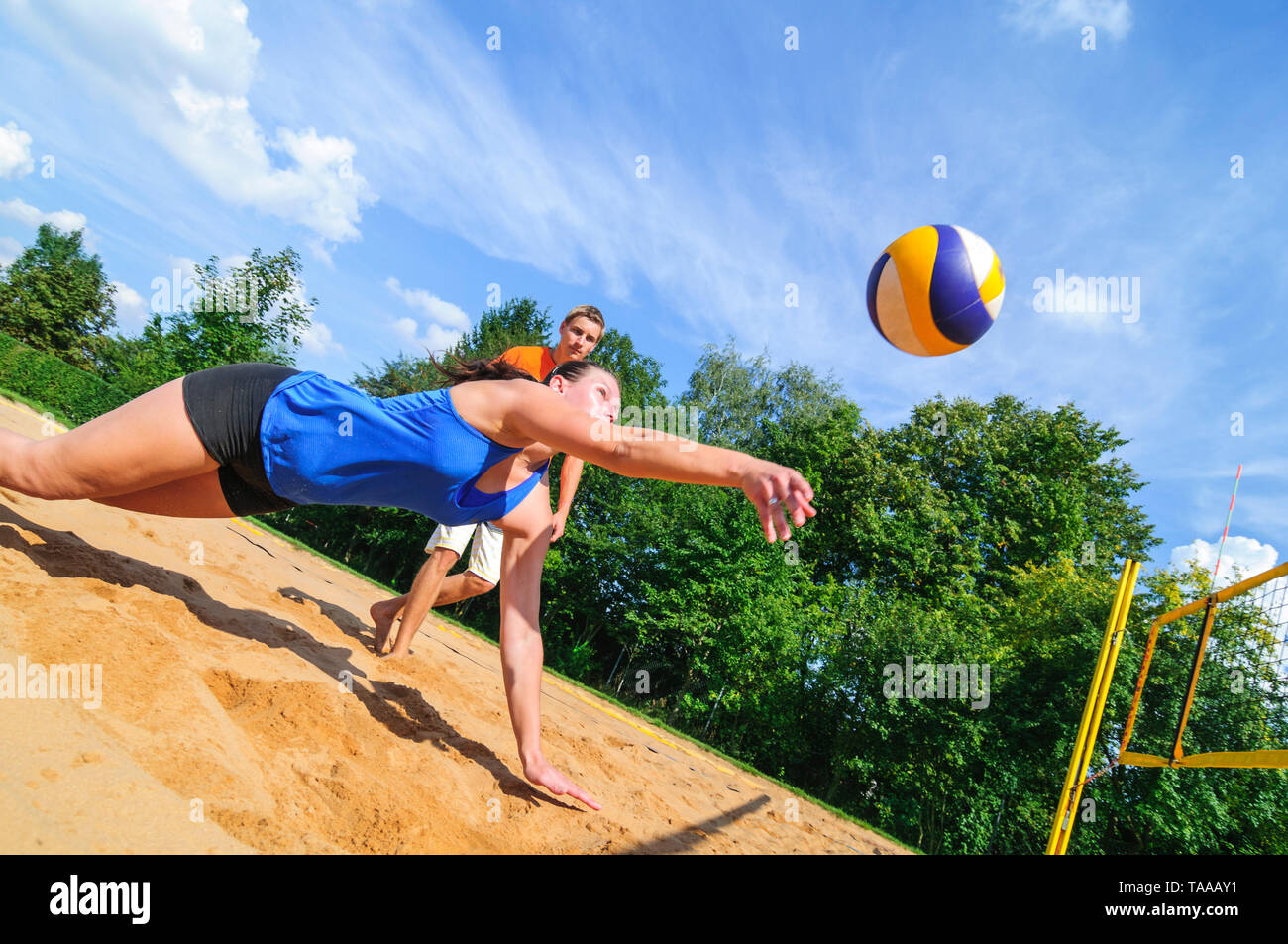 Intensive game on beachvolleyball court, fighting spirit to save the ...