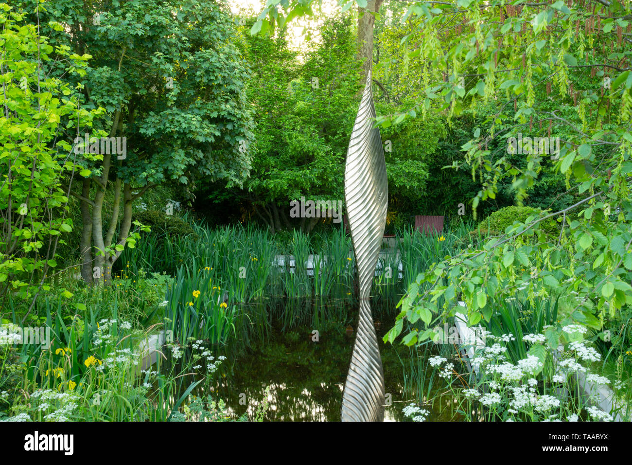 A central pool and sculpture surrounded by wild flowers in the Savills ...