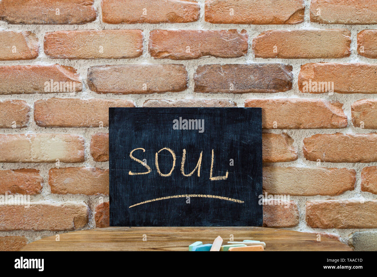 Chalk board with the word SOUL drown by hand and chalks on wooden table ...