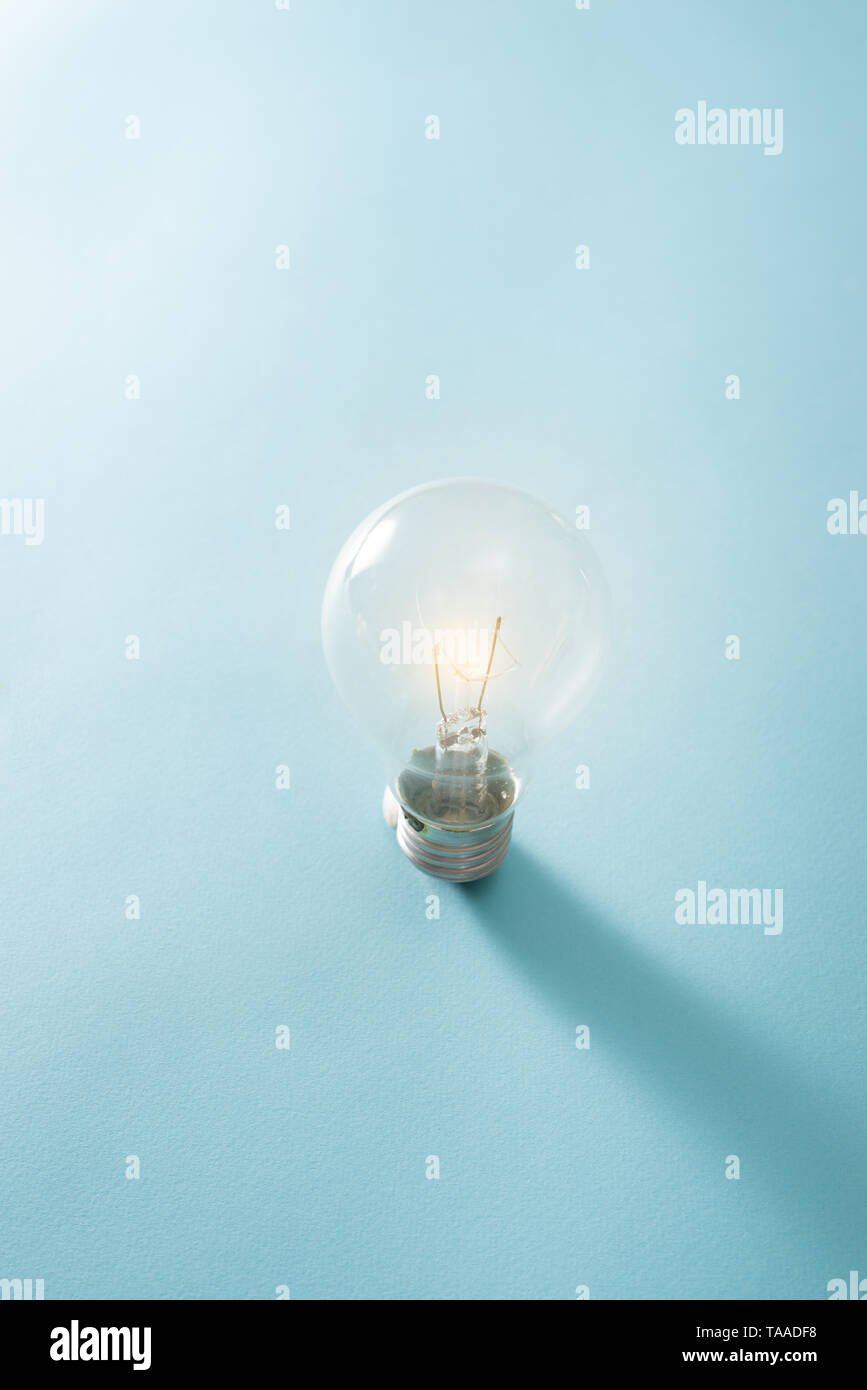 Light bulb with blue background hi-res stock photography and images - Alamy