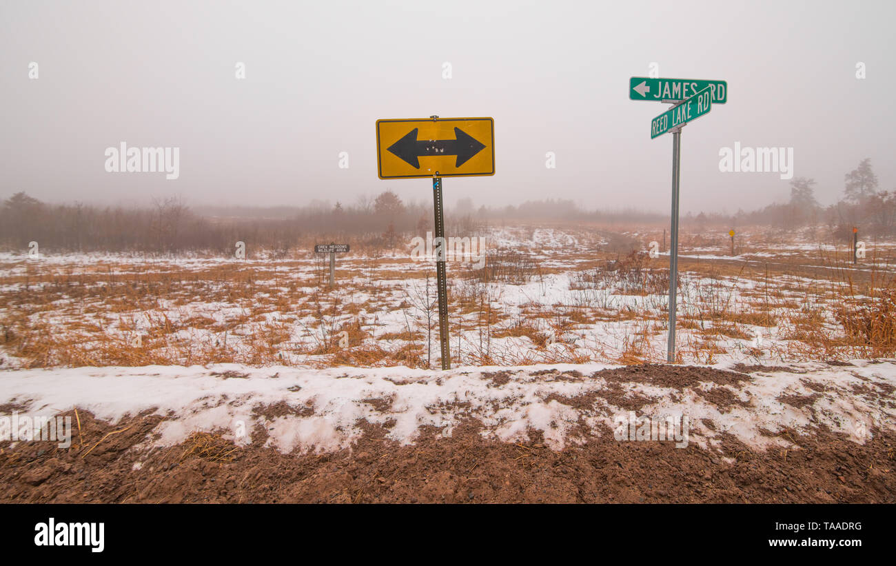 Street signs and arrow(s) sign - cross-section of two rural gravel ...