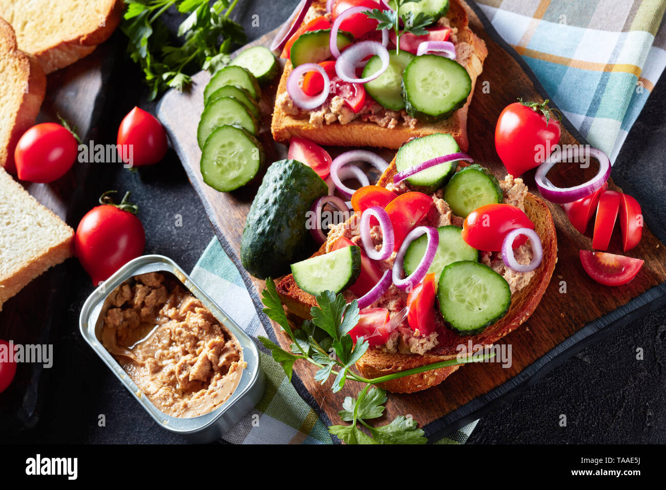 close-up of toasts with Cod Liver pate, topped with sliced cucumber ...