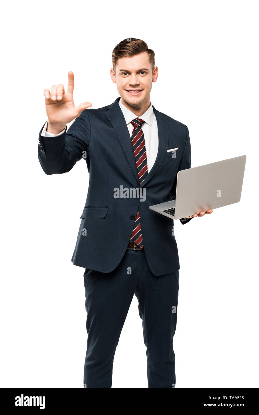 cheerful man pointing with finger while holding laptop isolated on ...