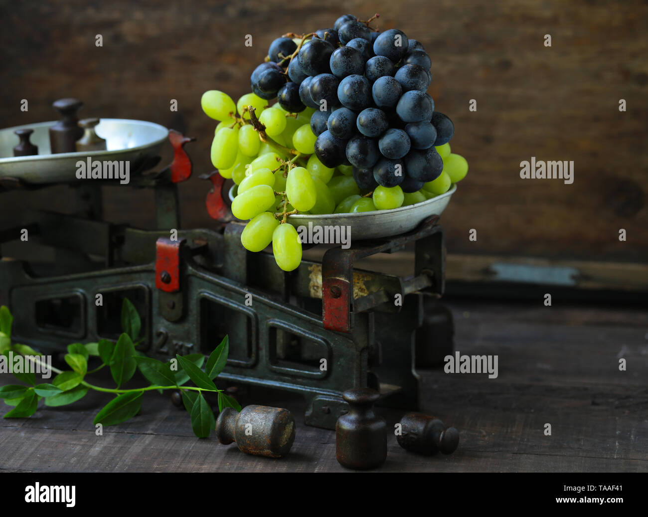 organic ripe grapes on scales, rustic style Stock Photo - Alamy