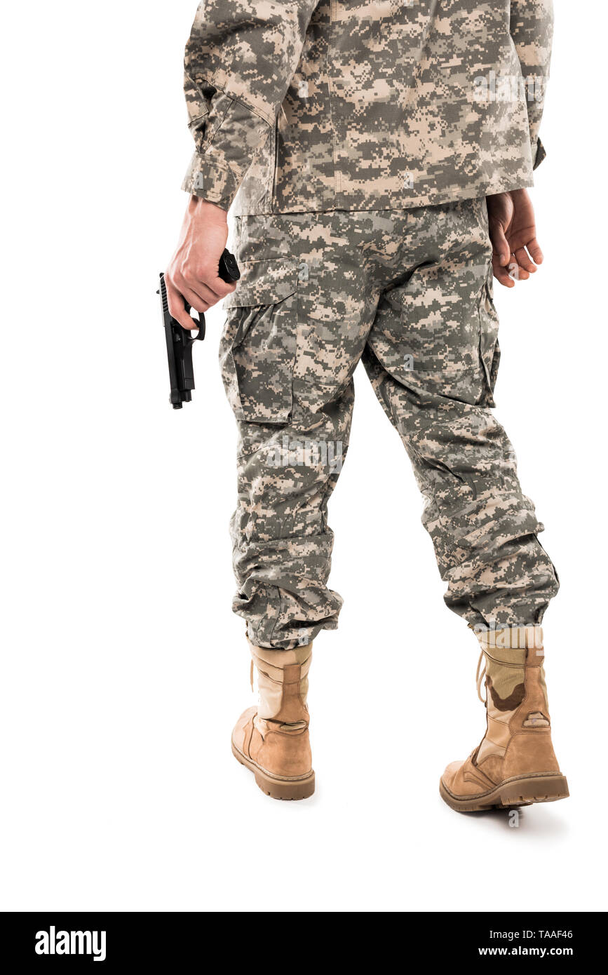 cropped view of man in military uniform holding gun isolated on white ...