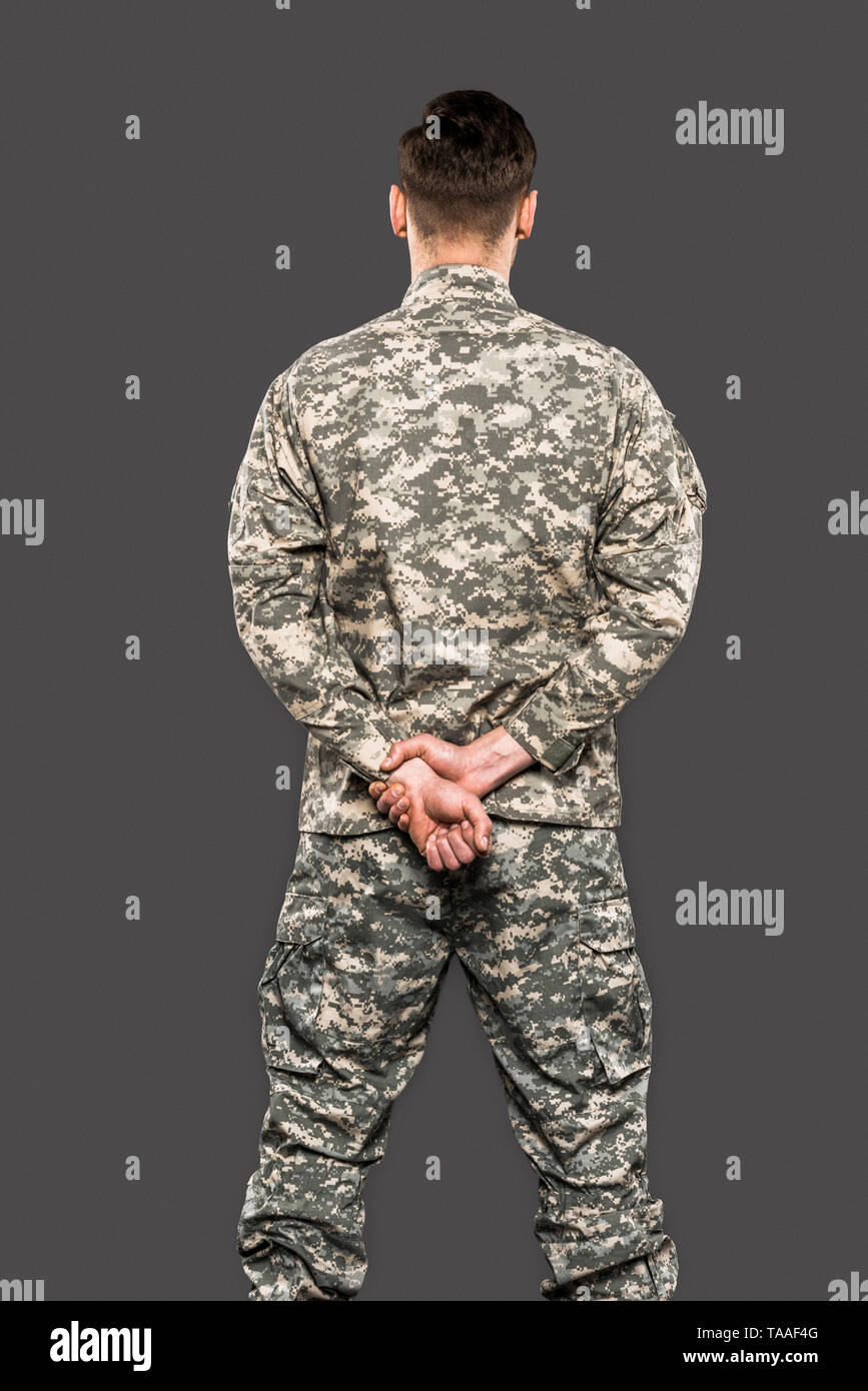 back view of soldier standing isolated on grey Stock Photo - Alamy