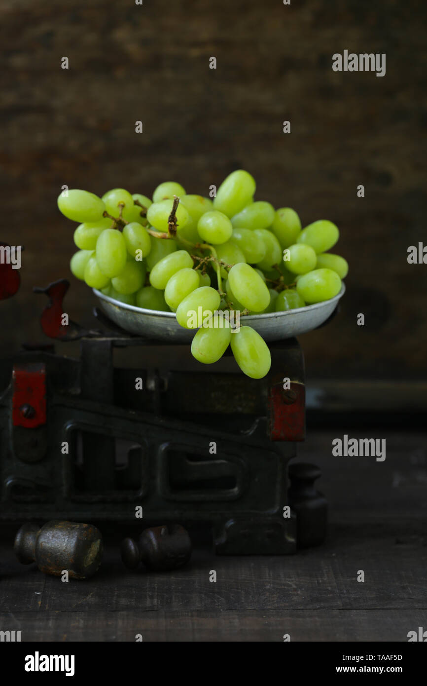 organic ripe grapes on scales, rustic style Stock Photo - Alamy