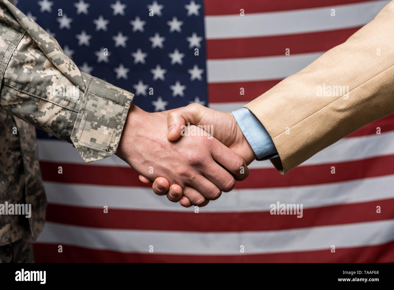 selective focus military men shaking hands near american flag Stock ...