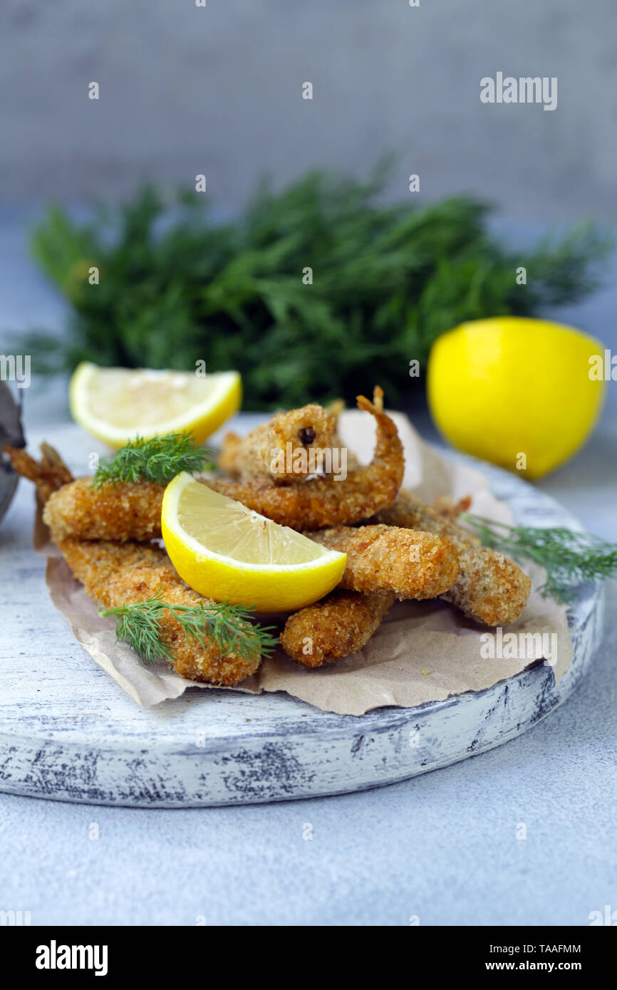 fried fish for lunch, with lemon and herbs Stock Photo - Alamy