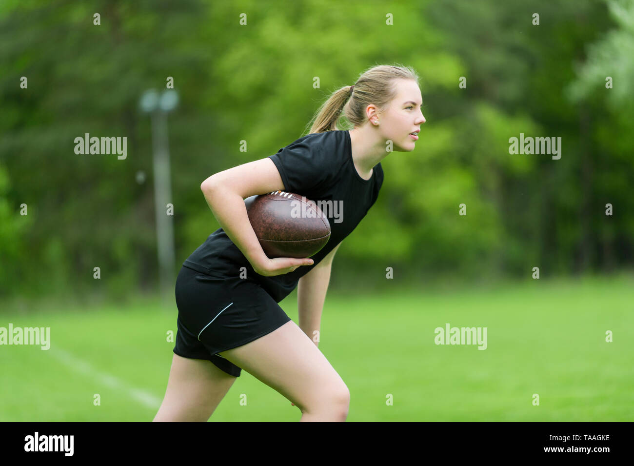 Girl playing rugby together outside in summer Stock Photo - Alamy