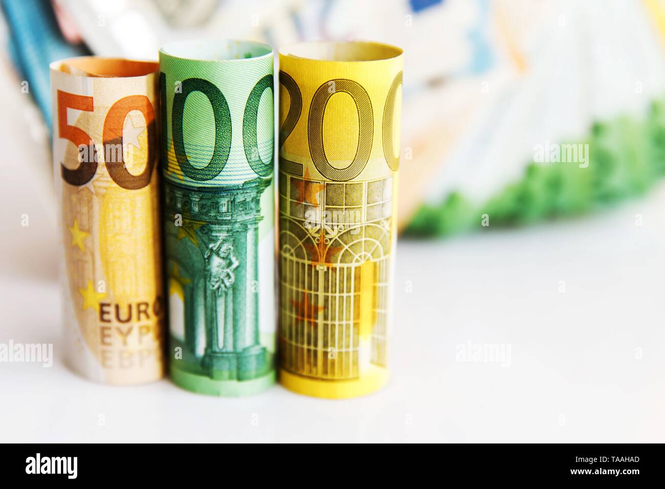Banknotes of different denominations are placed on a white background ...