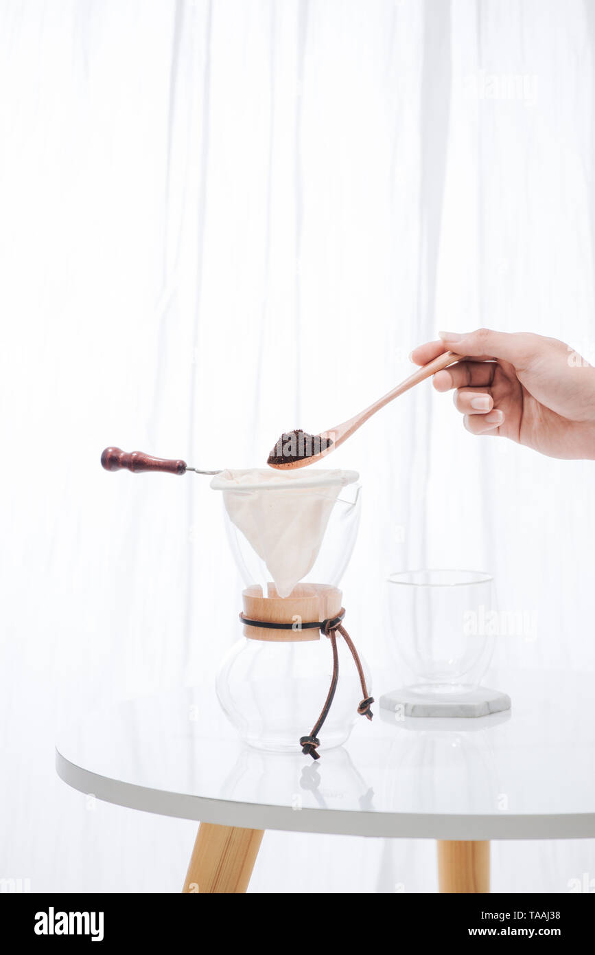 fill grind coffee in filter with wooden spoon Stock Photo - Alamy