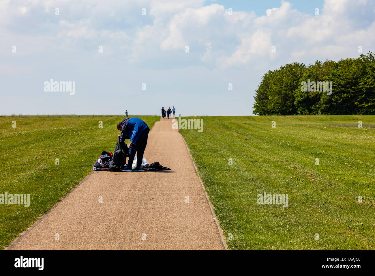 A man unpacks a rucksack on a footpath across Gillingham Lines, Medway ...
