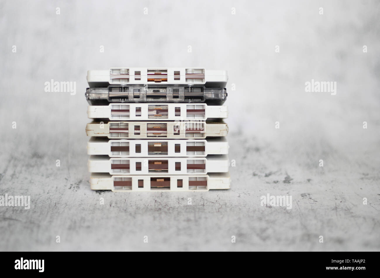 Stacked white cassette tapes on gray background Stock Photo - Alamy