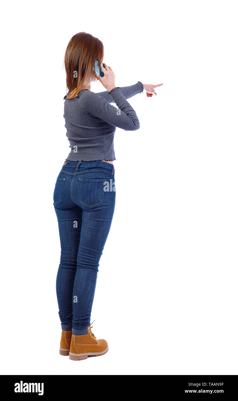 Back view of pointing young women talking on cell phone. Young girl ...