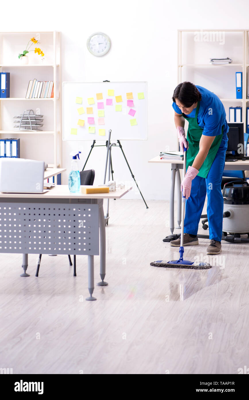 Male handsome professional cleaner working in the office Stock Photo ...